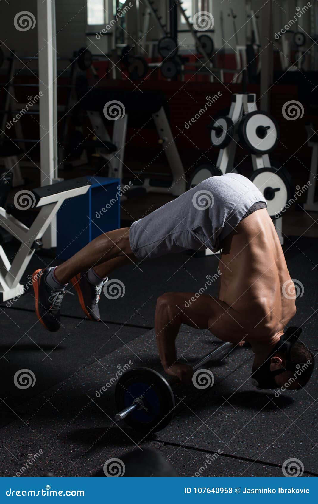 Bodybuilder Exercising Push-Ups on Barbell in Elevation Mask Stock ...