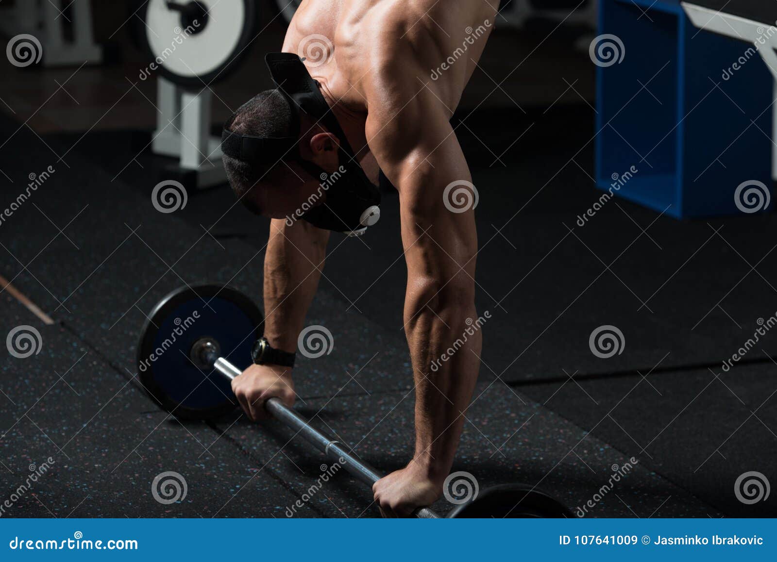 Bodybuilder Exercising Push-Ups on Barbell in Elevation Mask Stock ...