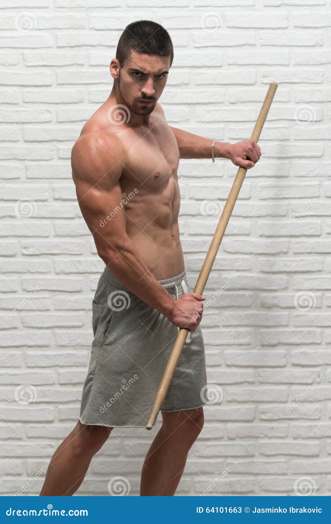 Bodybuilder is Exercising with Stick at the Wall Stock Image - Image of ...