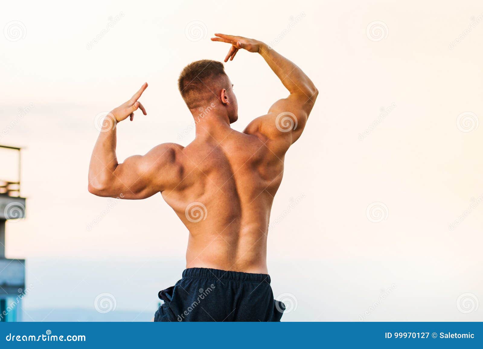 Bodybuilder Flexing Muscles on a Rooftop Stock Image - Image of ...