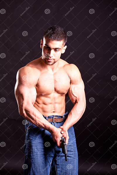 Bodybuilder with gun stock image. Image of attractive - 32441995