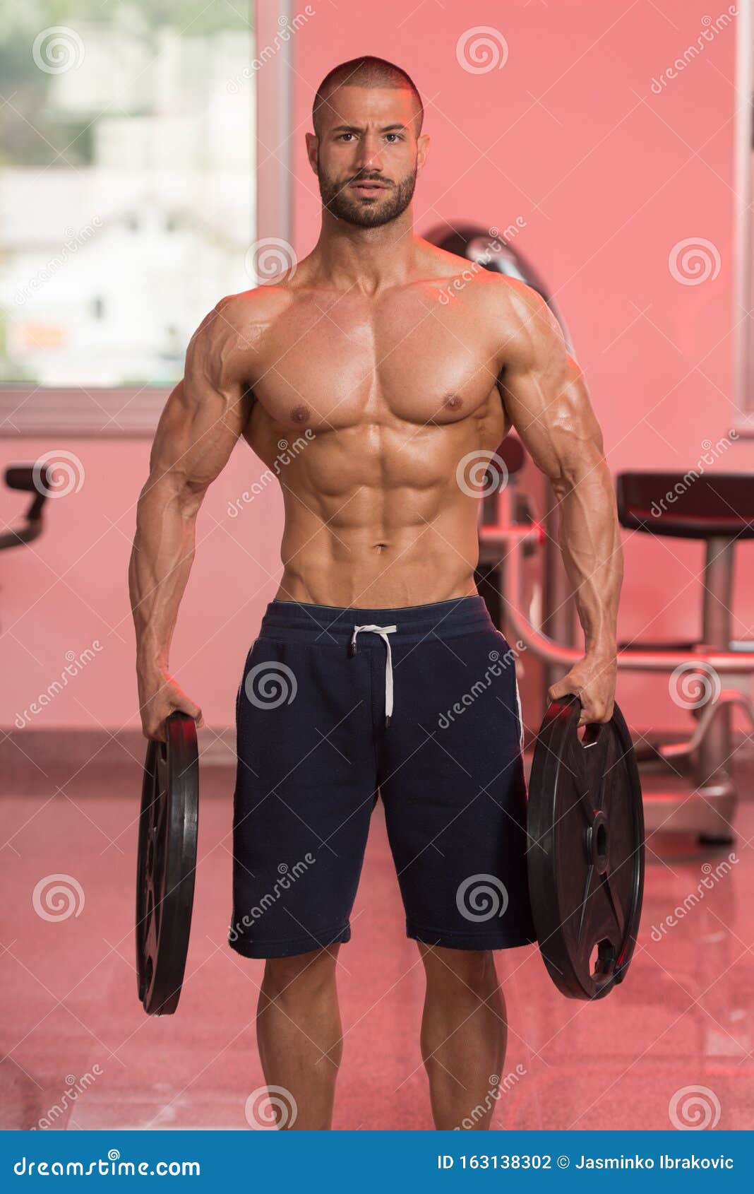 Bodybuilder Holding Weights in Hand Stock Photo - Image of indoors ...