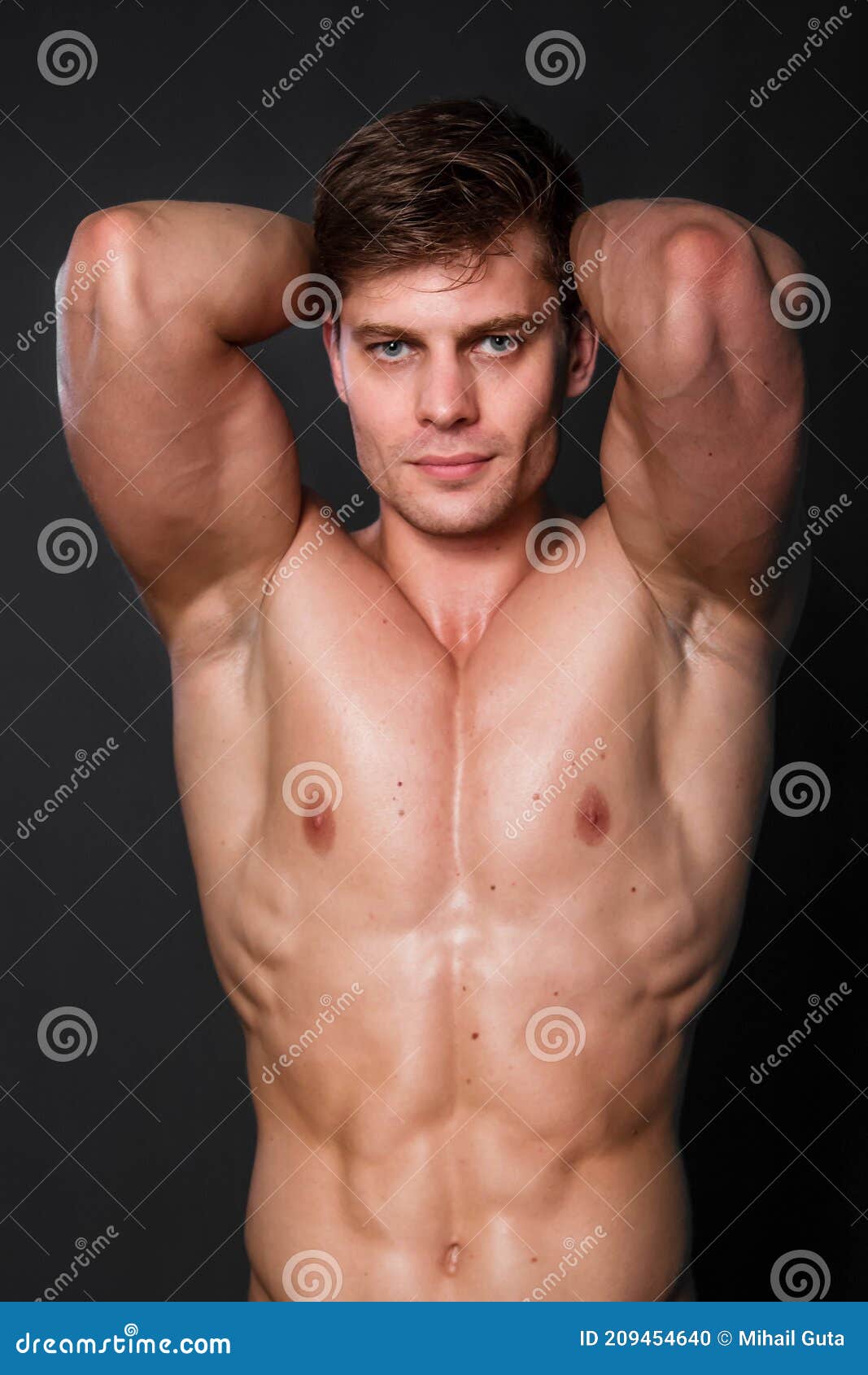 Bodybuilder Holds Muscular Arms on Head. Photo in Studio on a Black ...