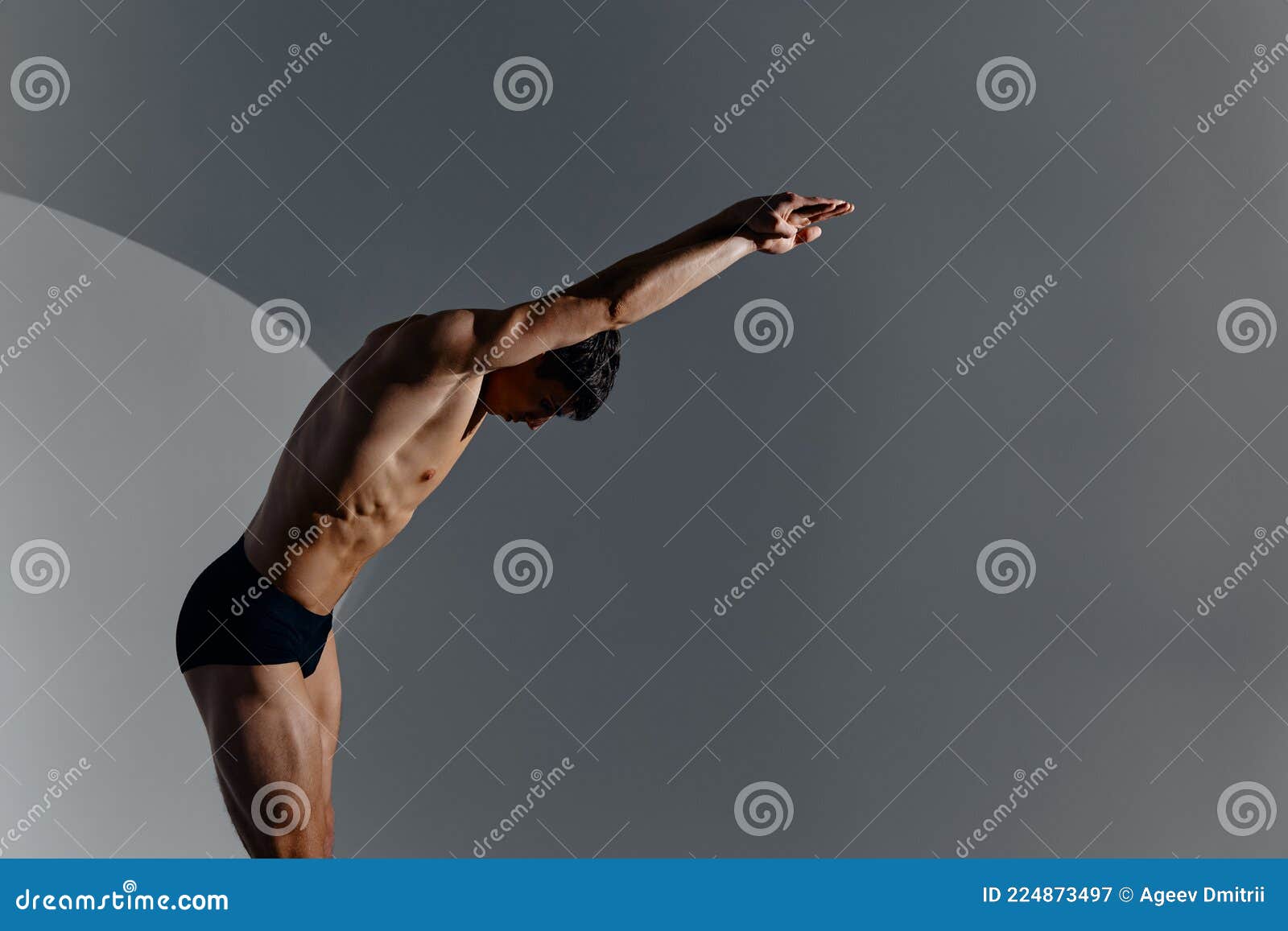 Bodybuilder Man with a Pumped-up Torso and with Raised Arms Leaned ...