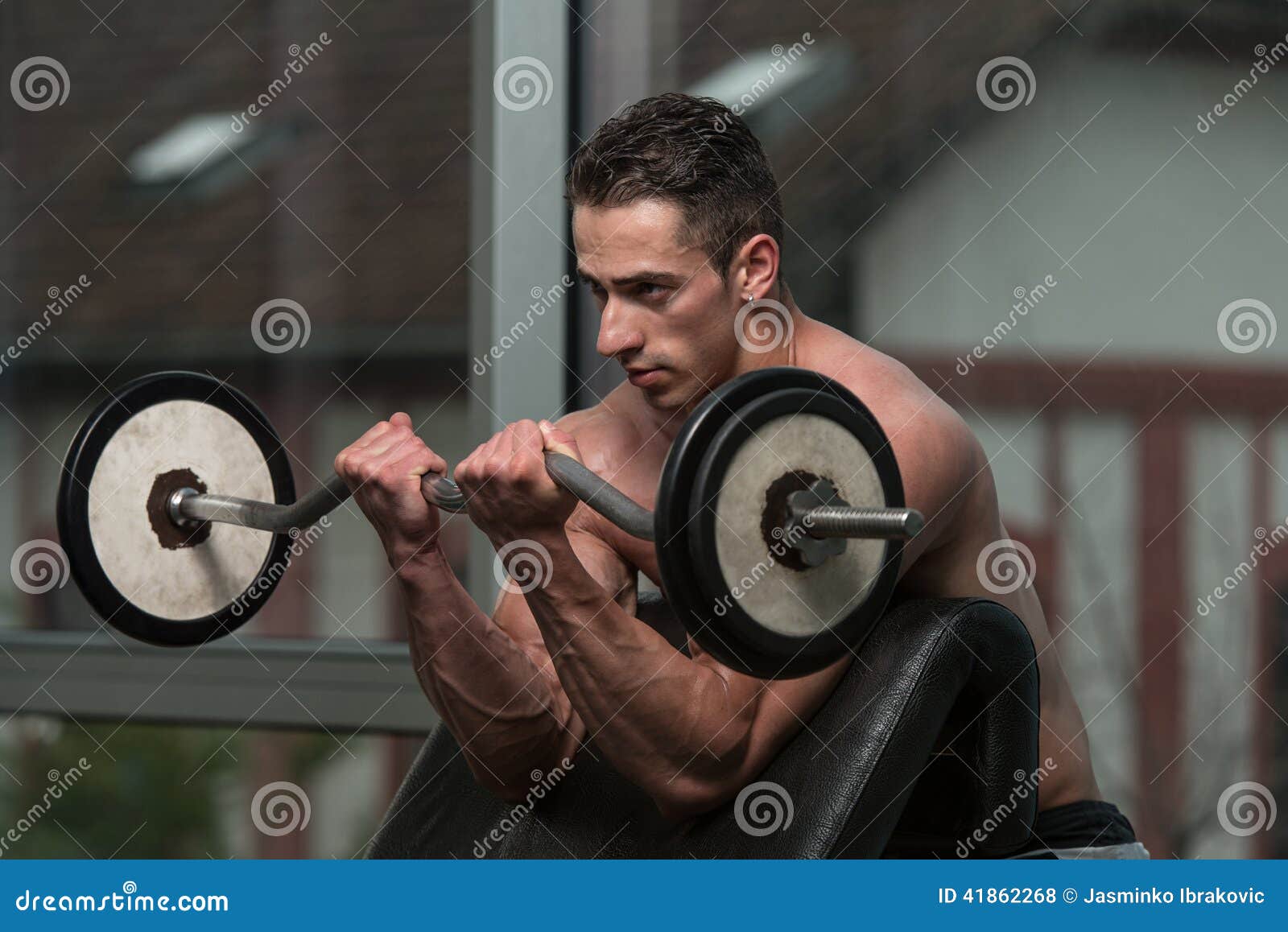 Bodybuilder Performing Biceps Curls with a Barbell Stock Photo - Image ...