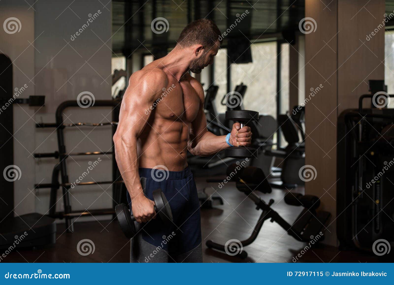 Bodybuilder Performing Biceps Curls with Dumbbells Stock Image - Image ...