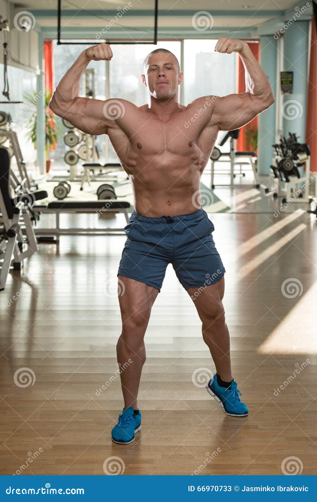 Bodybuilder Performing Double Biceps Pose Stock Image - Image of ...