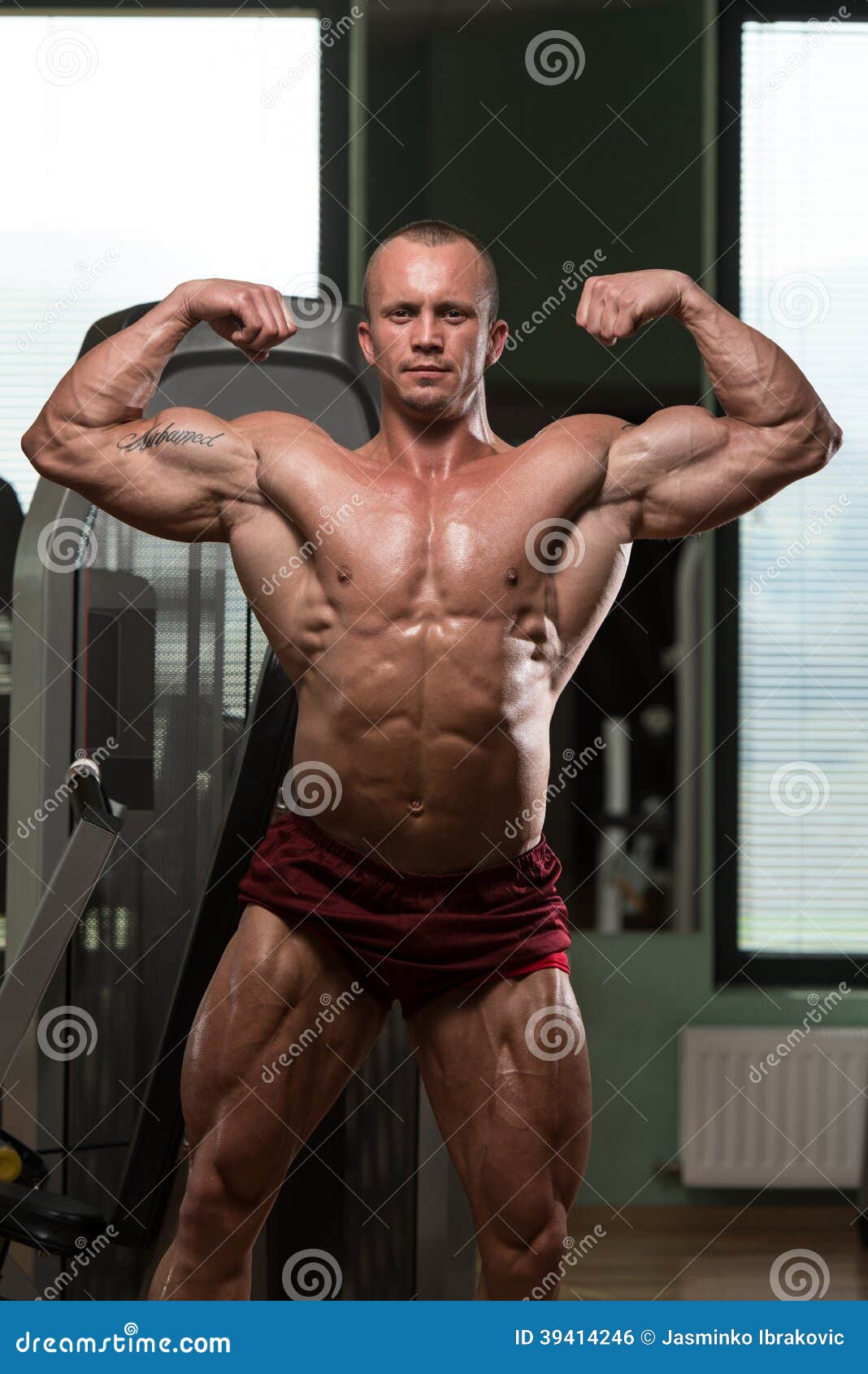 Bodybuilder Performing Front Double Biceps Pose Stock Photo - Image of ...
