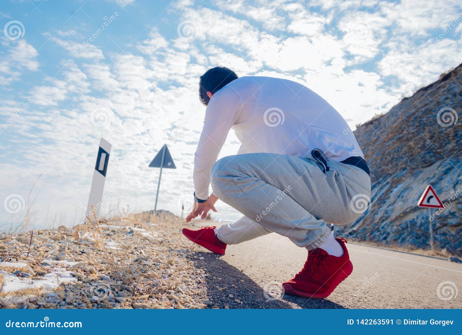 Bodybuilder Performing His Stretching Routine in the Morning on an ...