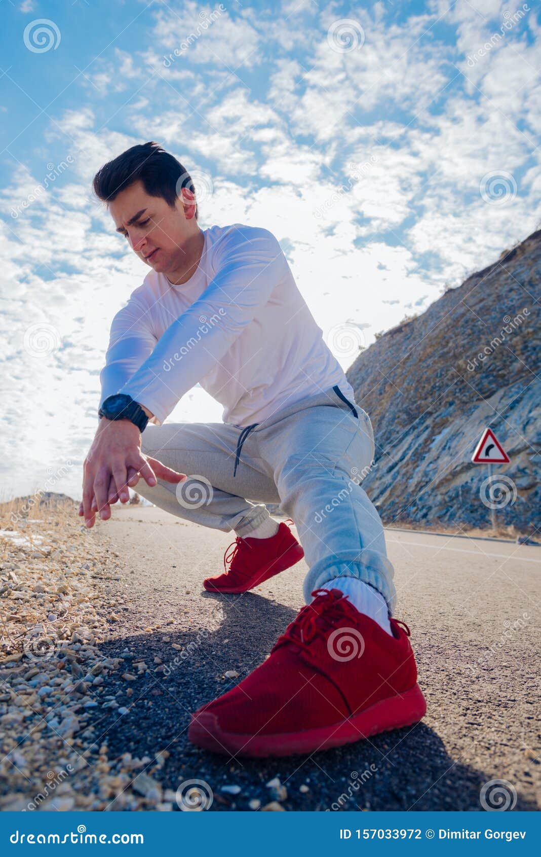 Bodybuilder Performing His Stretching Routine in the Morning on an ...