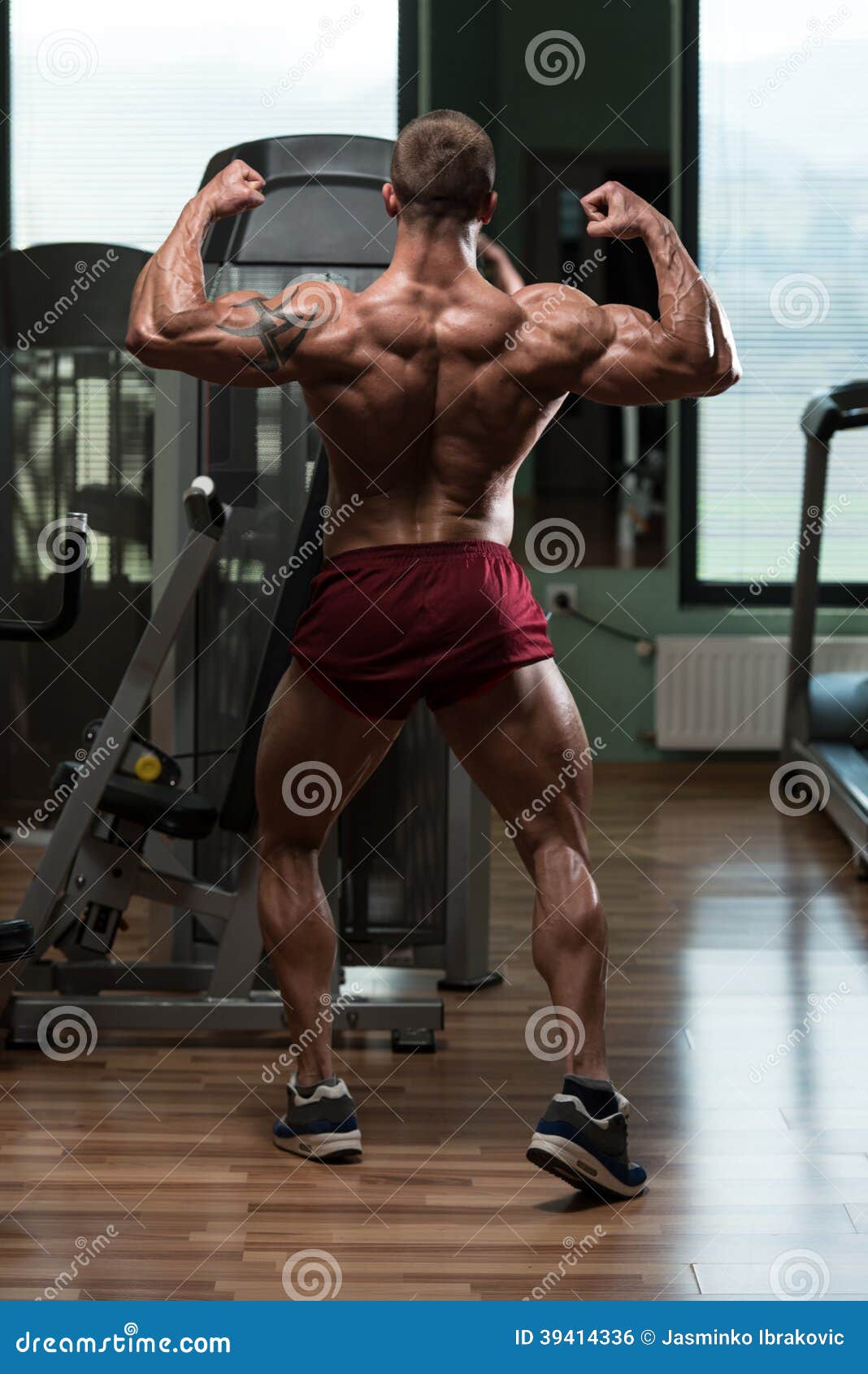 Bodybuilder Performing Rear Double Biceps Pose Stock Photo - Image of ...