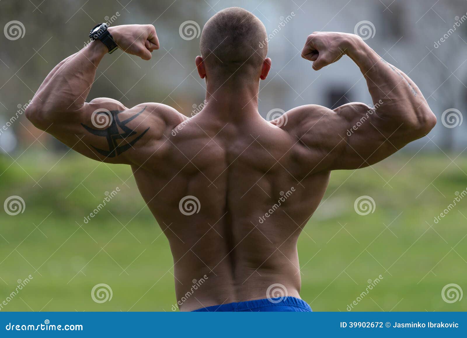 Bodybuilder Performing Rear Double Biceps Poses in Park Stock Photo ...