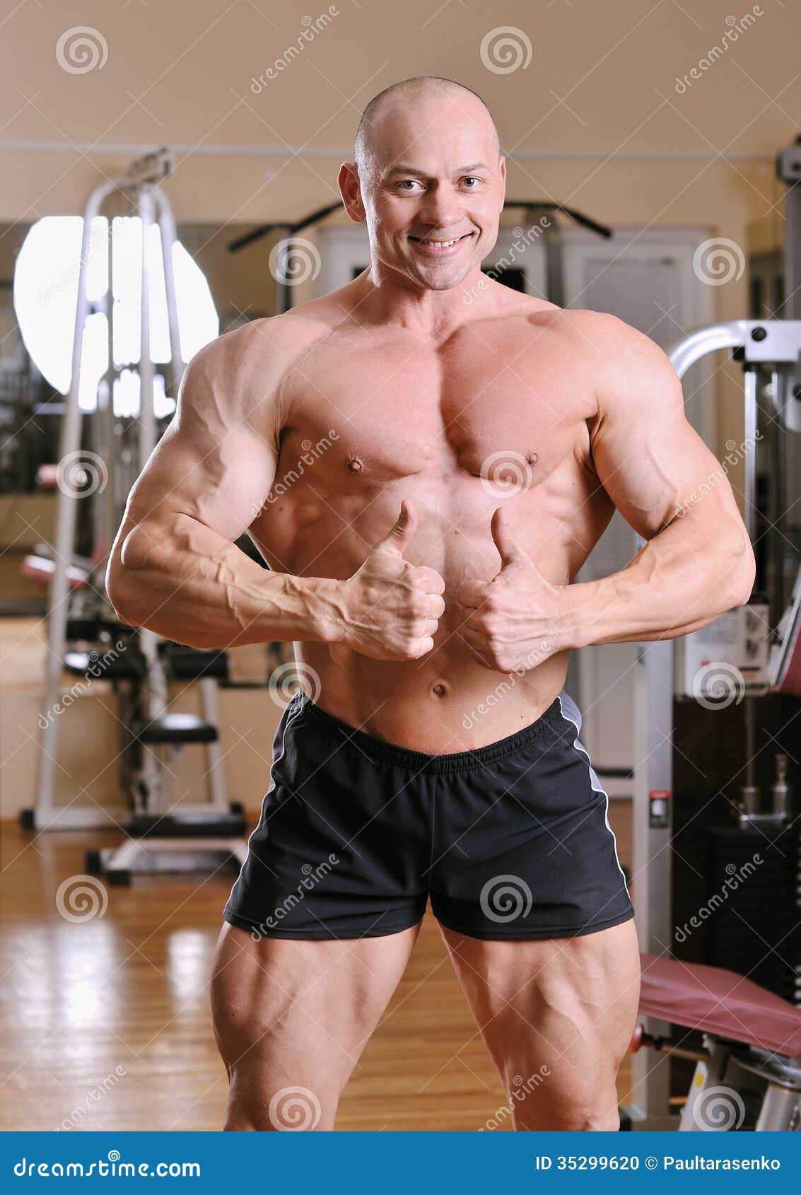 Bodybuilder posing at gym stock photo. Image of model - 35299620