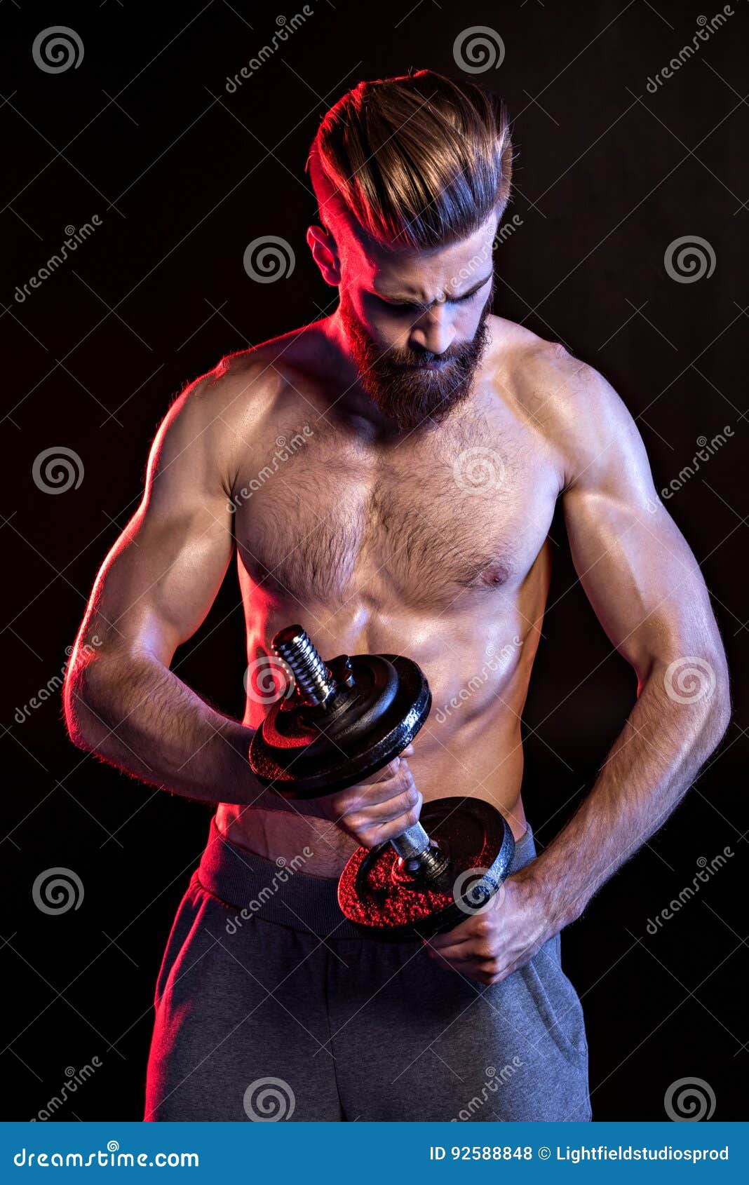 Bodybuilder Training with Dumbbell Isolated on Black with Dramatic ...