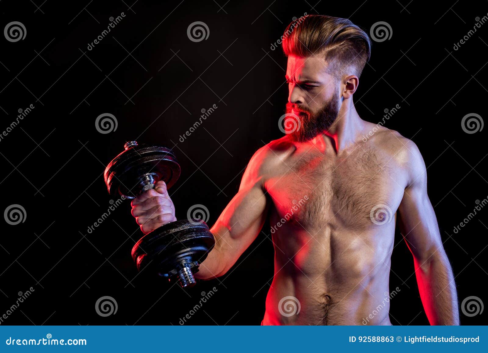 Bodybuilder Training with Dumbbell Isolated on Black with Dramatic ...