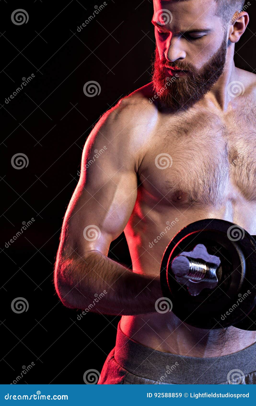Bodybuilder Training with Dumbbell Isolated on Black with Dramatic ...