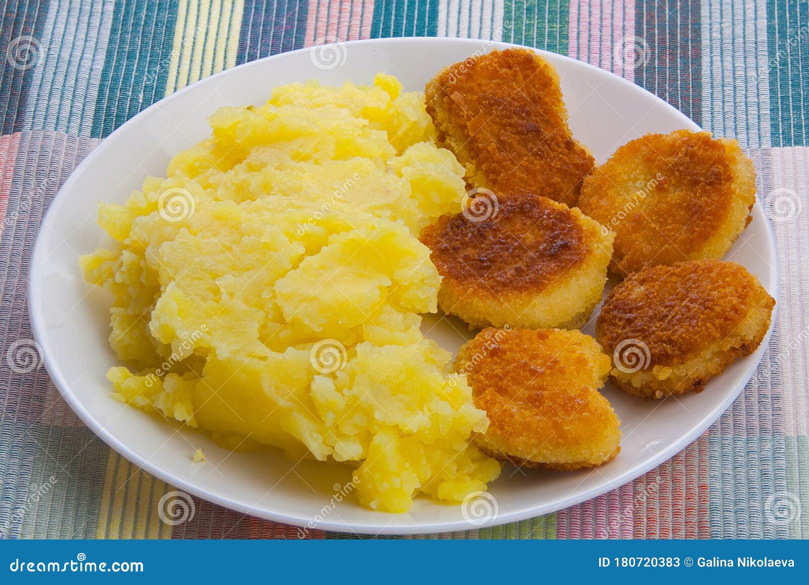Boiled Mashed Potatoes on a Plate with Chicken Nuggets on Table Stock ...