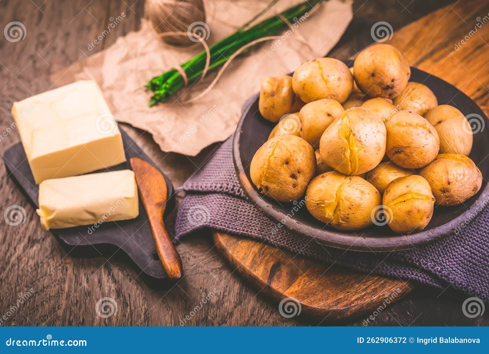 Boiled Young Potatoes with Butter and Chives on Cutting Board Stock ...
