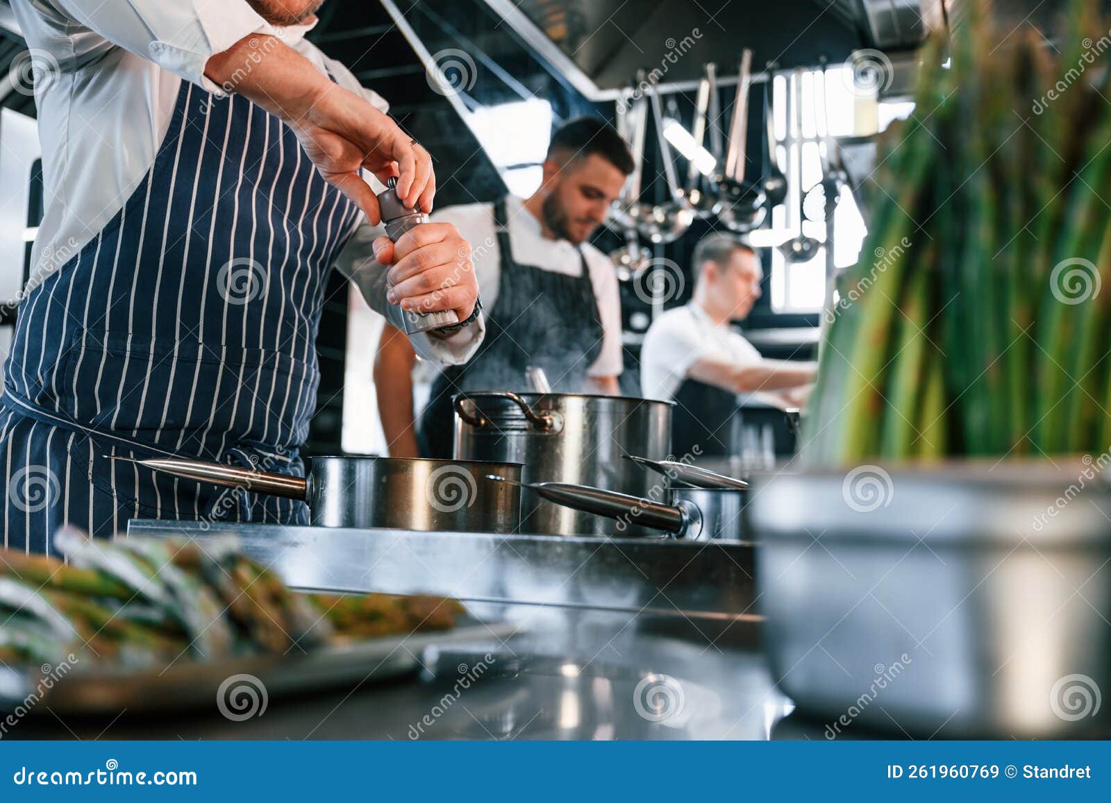 Boiling and Adding Ingredients. Kitchen Workers is Together Preparing ...
