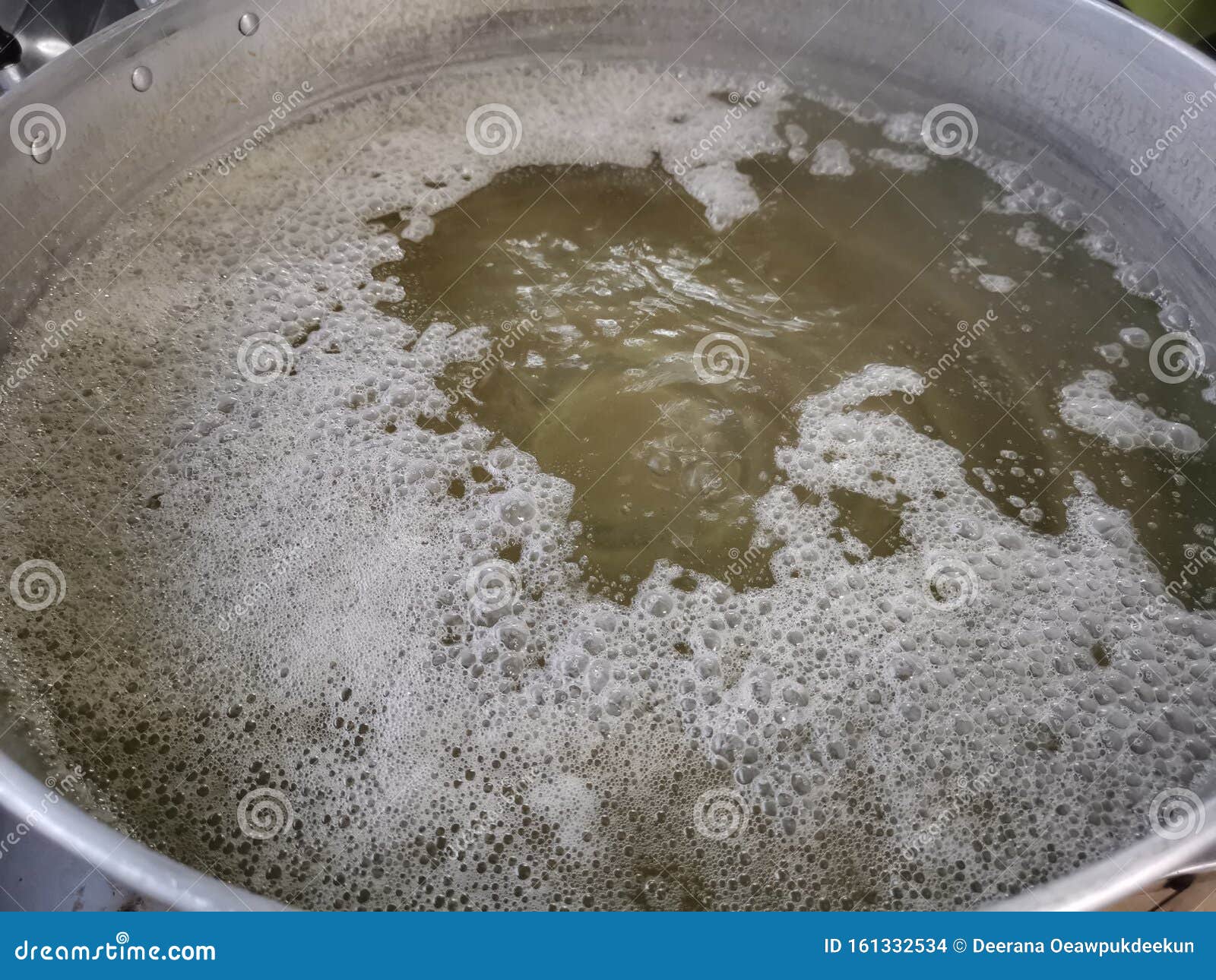 The Boiling Broth is Filled with White Bubbles Floating in a Large Pot ...