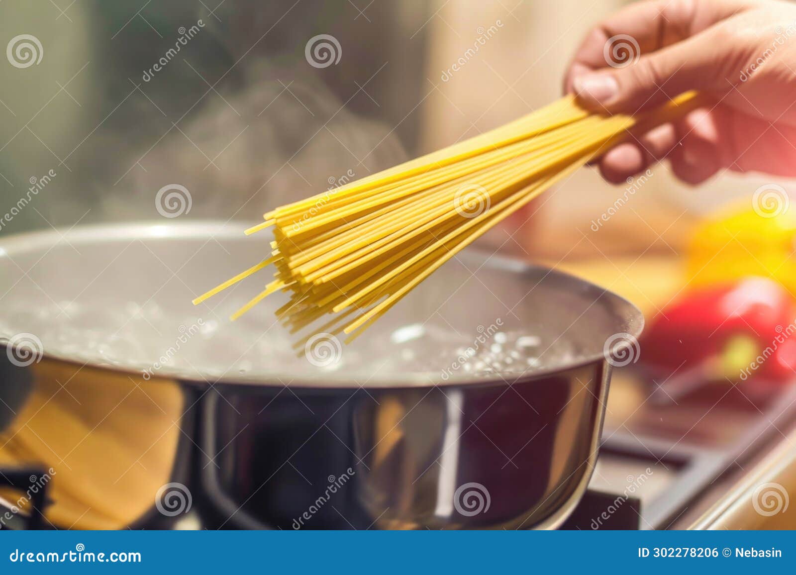 Boiling Spaghetti: Hand Placing Raw Pasta into a Pot of Boiling Water ...