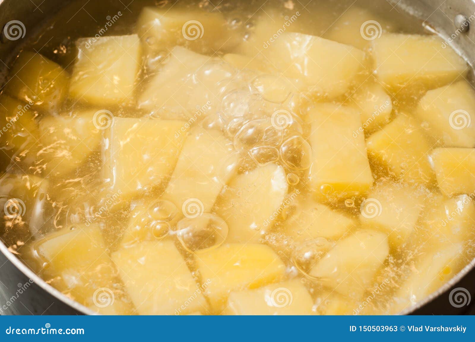 Boiling Water and the Process of Making Mashed Potatoes. Bubbles of ...