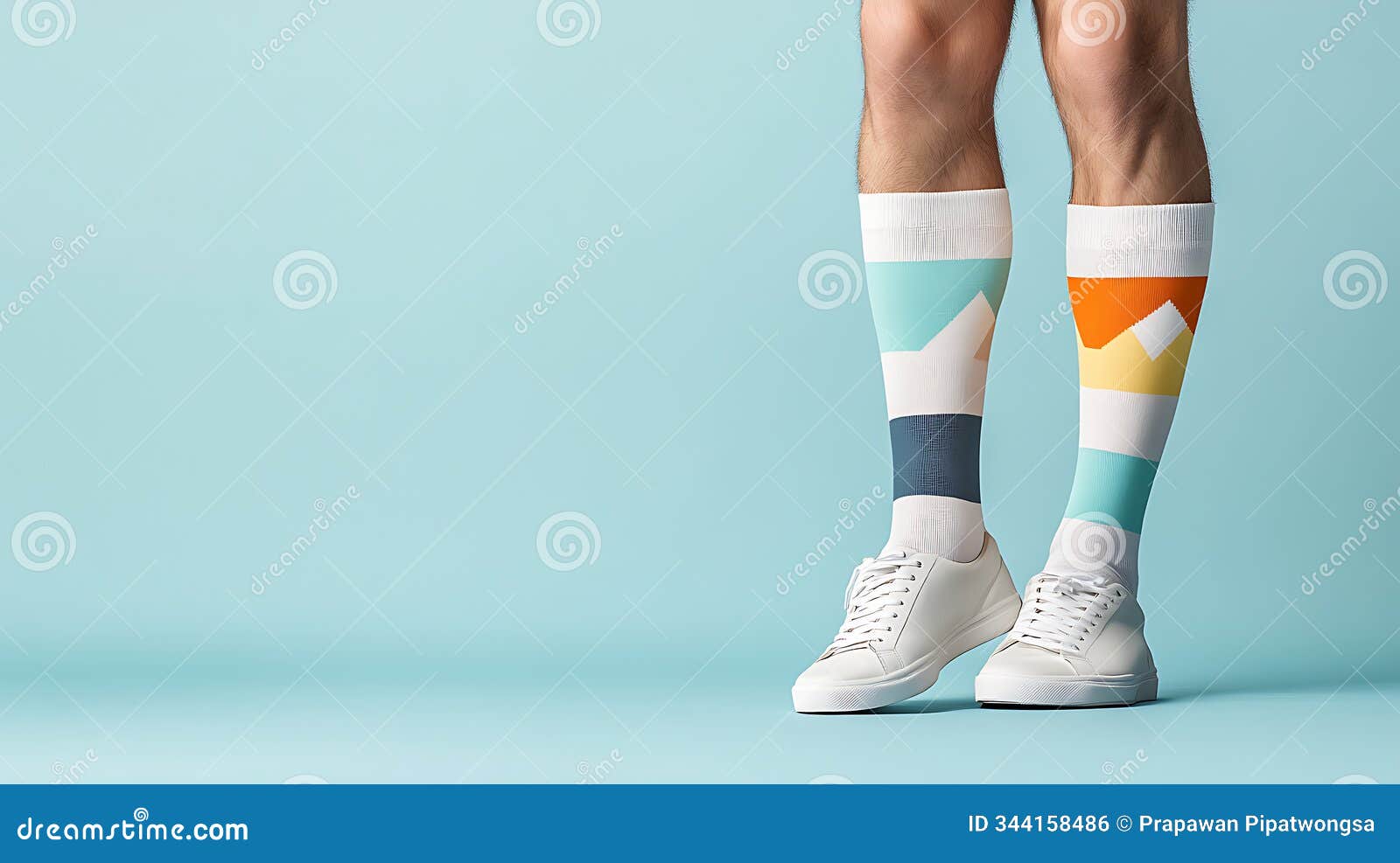 Bold Geometric Patterned Socks on Feet Standing on Light Blue ...
