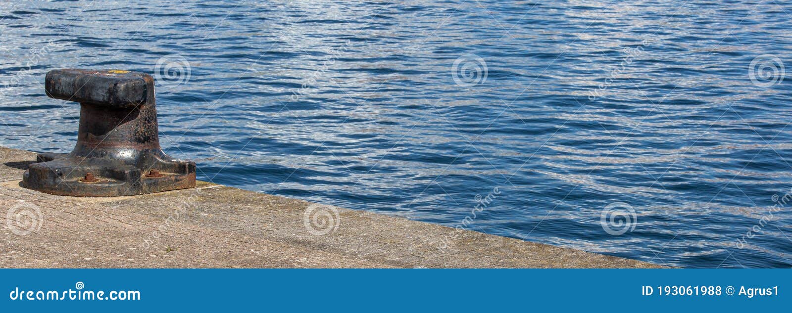 Bollar on Pier with Blue Water in Background Stock Photo - Image of ...