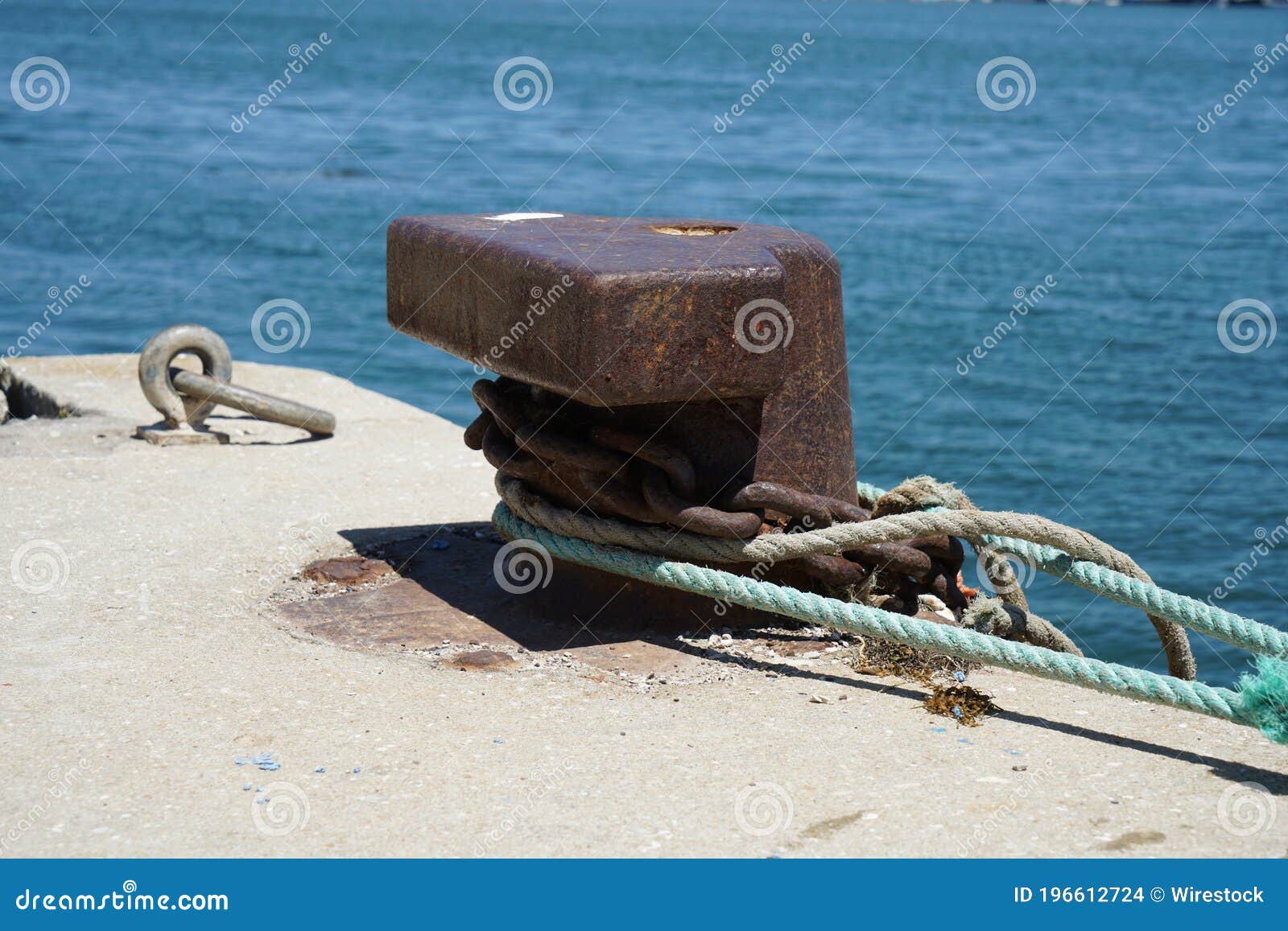 Bollard with Ropes on it on the Pier Stock Photo - Image of lighthouse ...