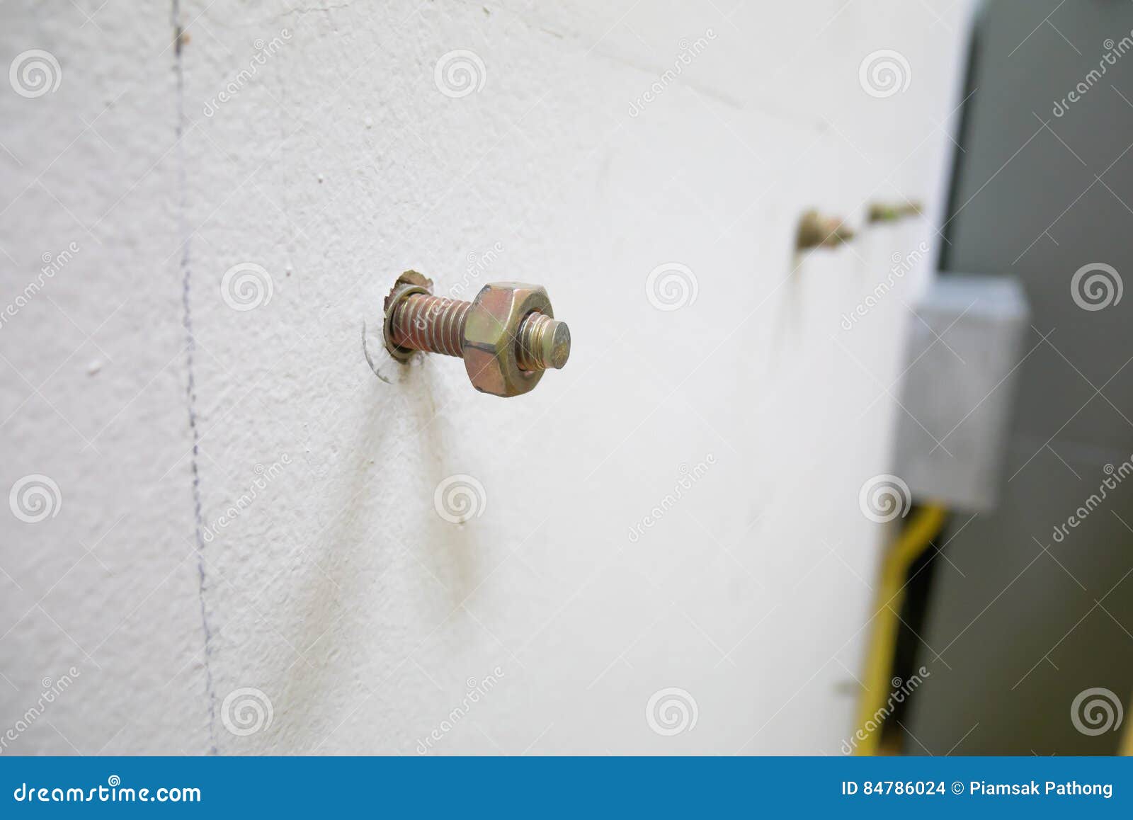 Bolt and nut on wall. stock photo. Image of industrial - 84786024