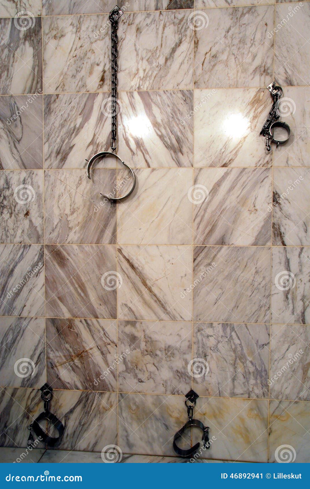 Bondage cuffs on tile wall stock image. Image of submissive - 46892941