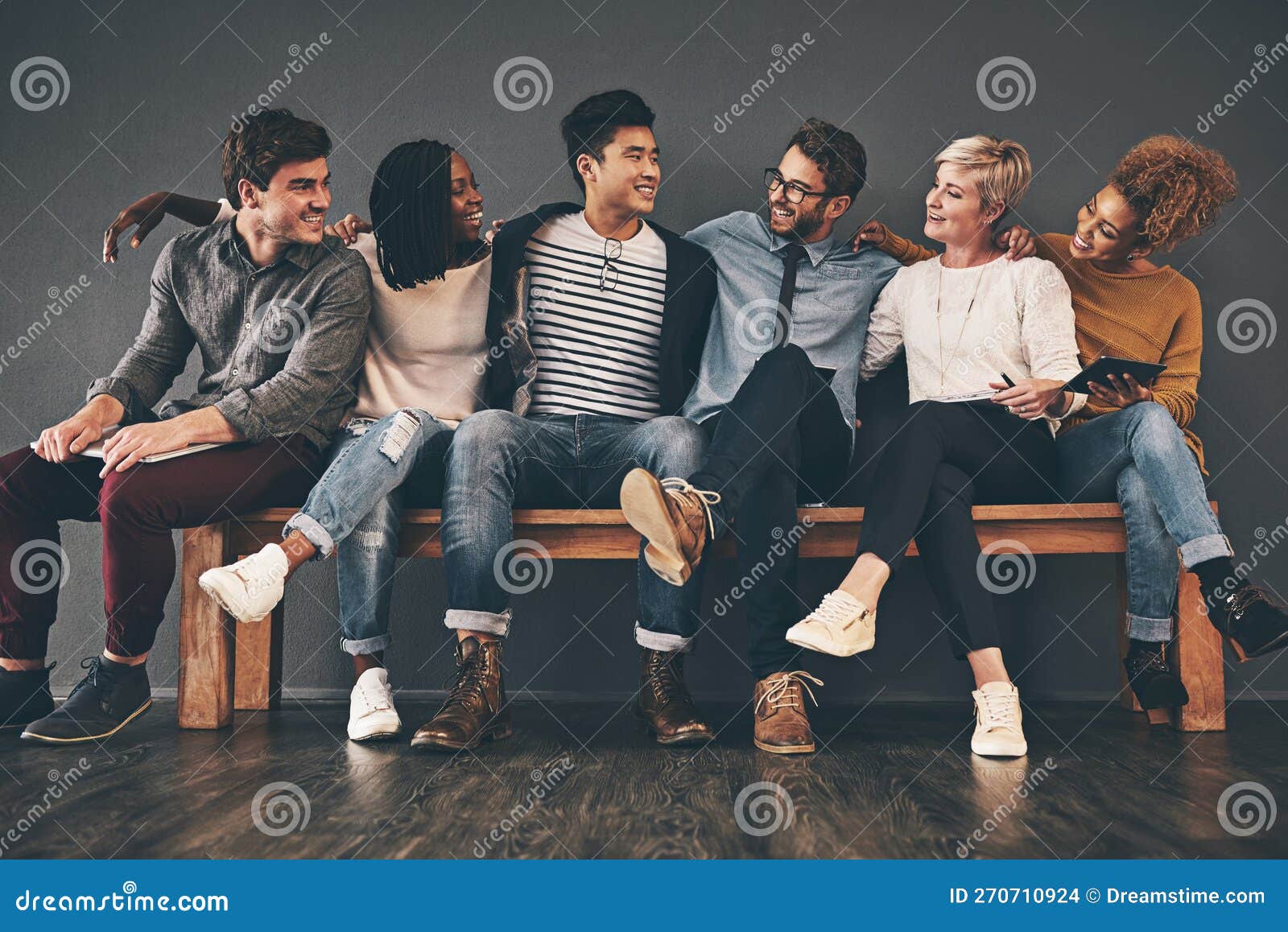 Bonding on the Bench. Studio Shot of a Diverse Group of Creative ...