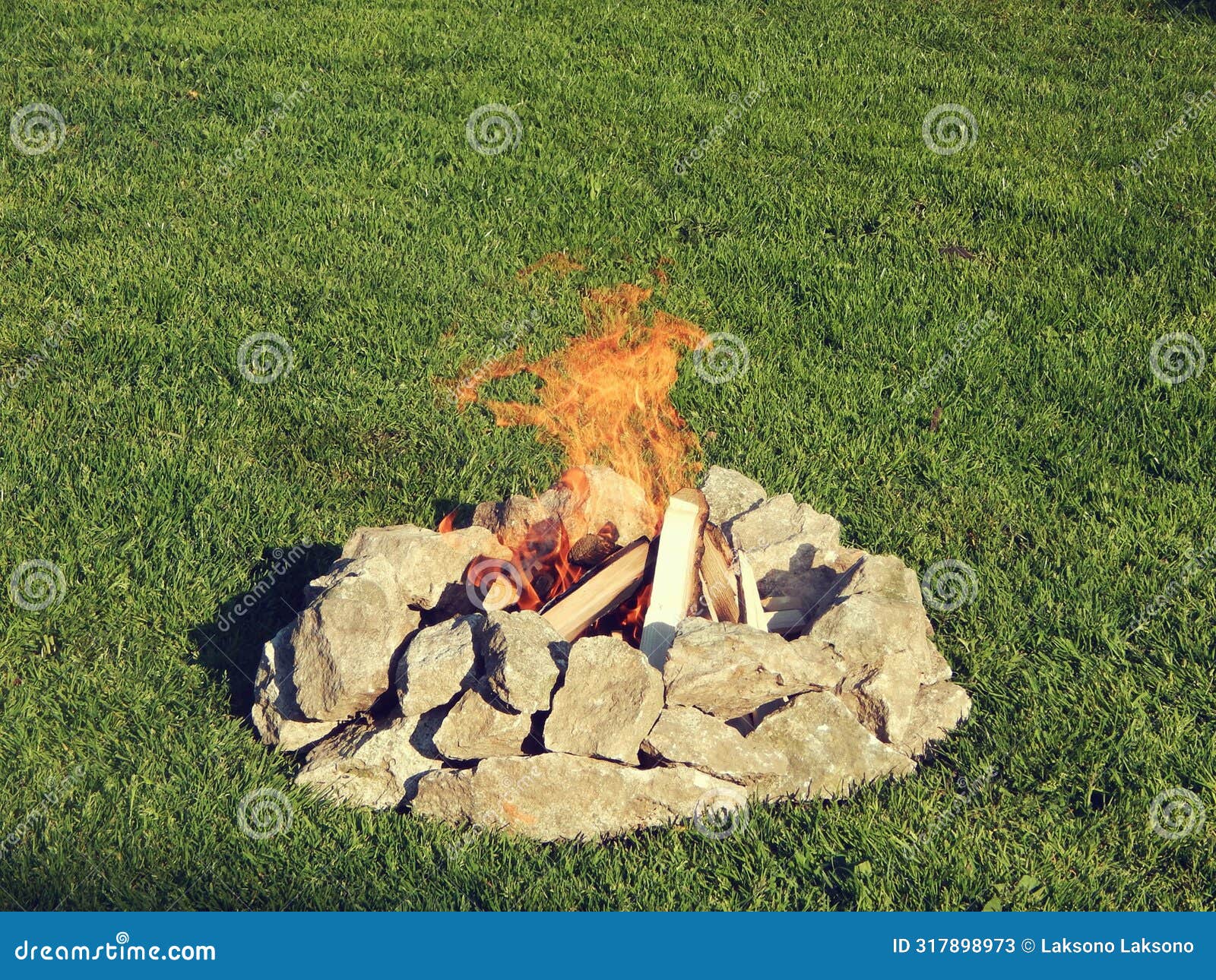 Bonfire in rocks on grass stock image. Image of grass - 317898973