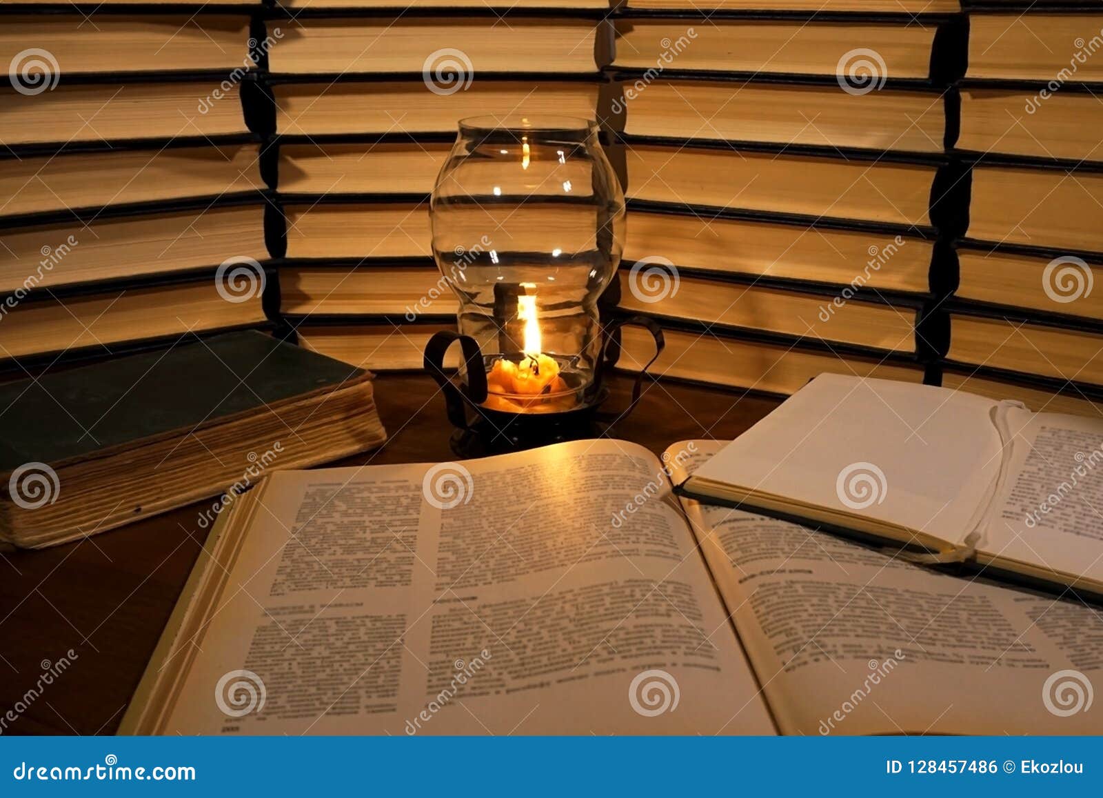 Book and Candle on the Table on the Background of Old Books Stock Photo ...