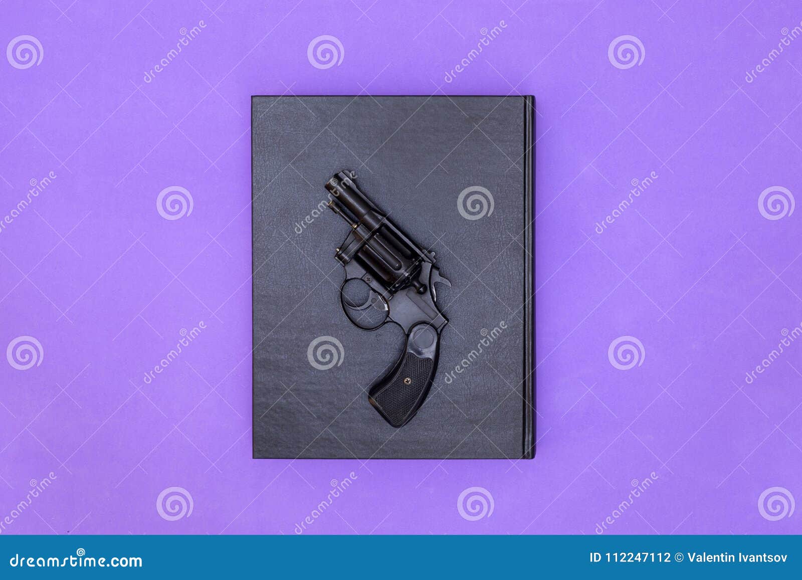 Book and Gun on a Purple Background. Stock Photo - Image of blue, paper ...