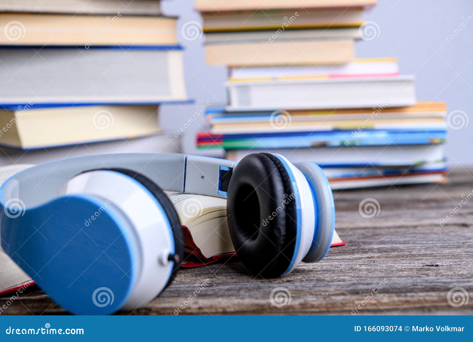 Book with Headphone in Front of Piles of Different Books Stock Photo ...