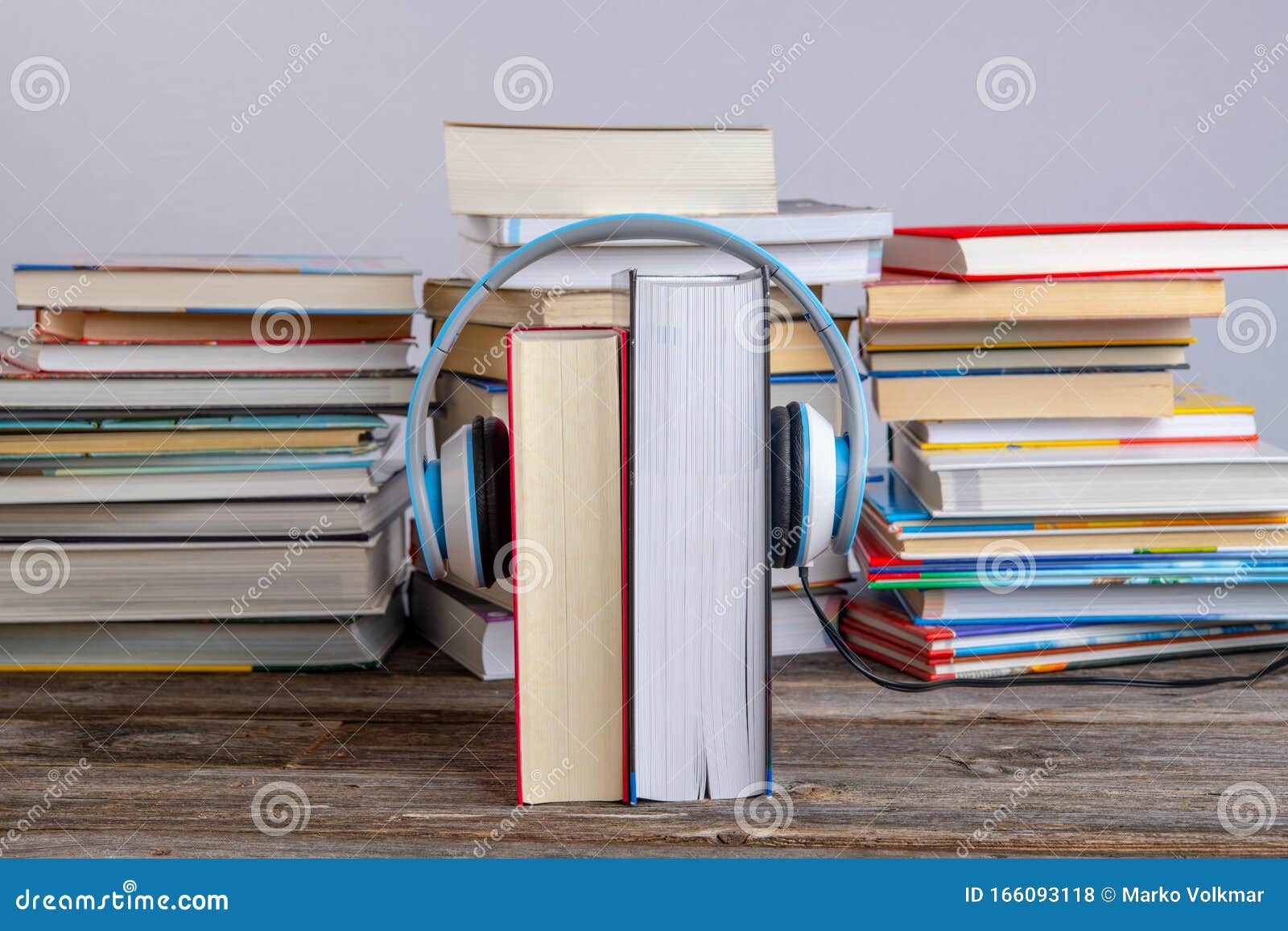 Book with Headphone in Front of Piles of Different Books Stock Photo ...