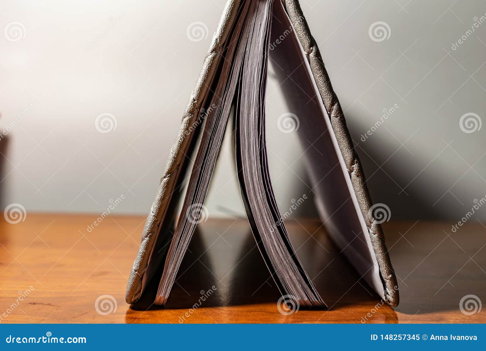 A Book, a Notebook with a Checkered Pattern on a Wooden Table in ...