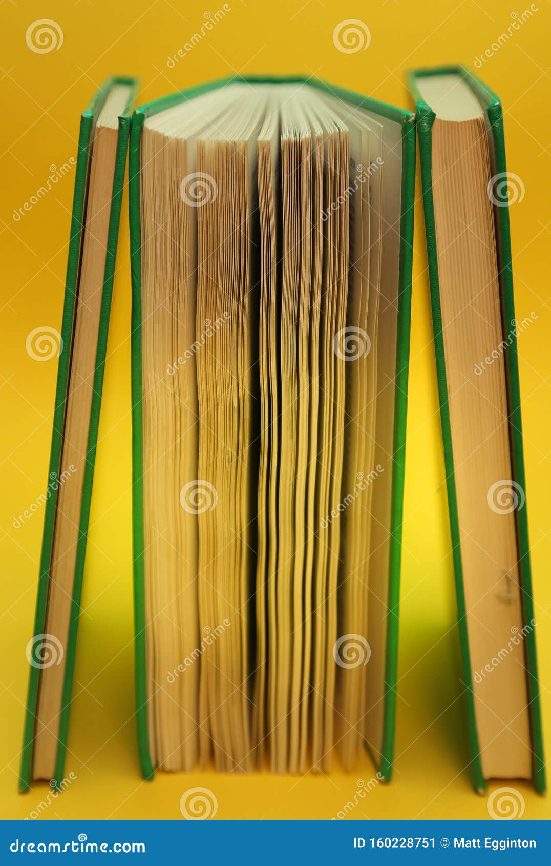 Book Standing Vertically Over a Yellow Background Stock Image - Image ...