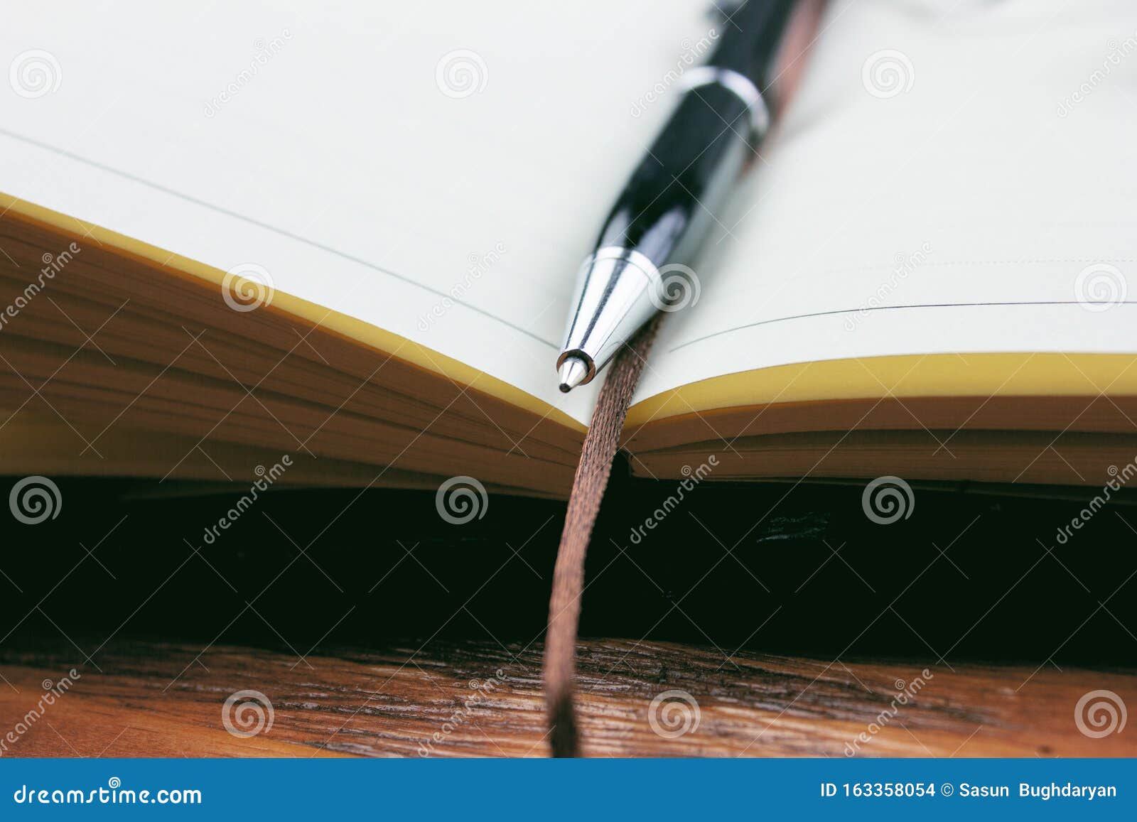 Book with a Pen on a Wooden Table Editorial Stock Image - Image of ...