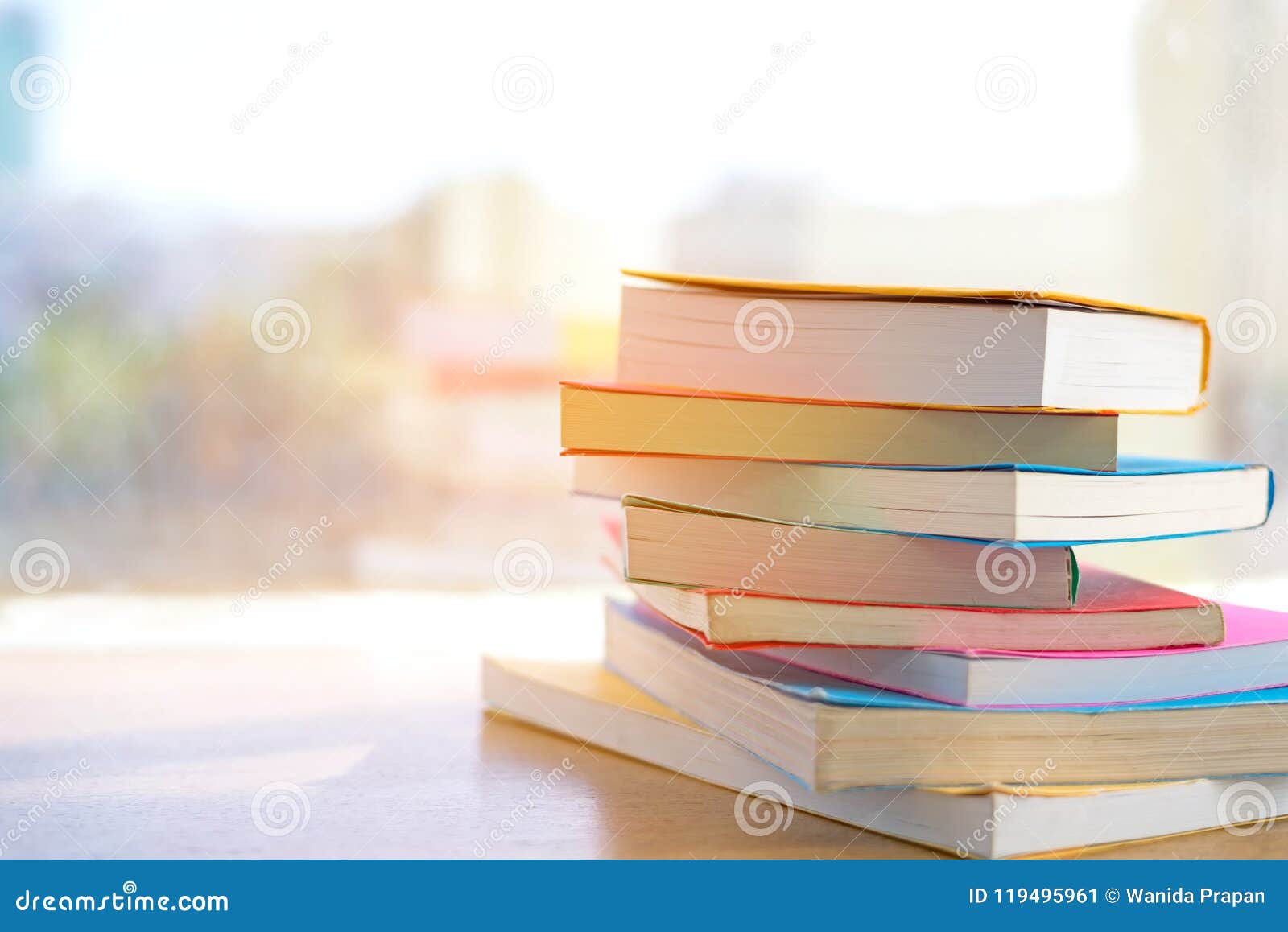Stack Of Book And A Holy Bible On Wooden Table Over Sea And Blue Sky ...
