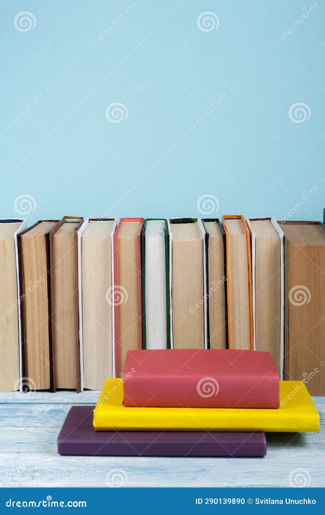 Book Stacking. Open Book, Hardback Books on Wooden Table and Blue ...