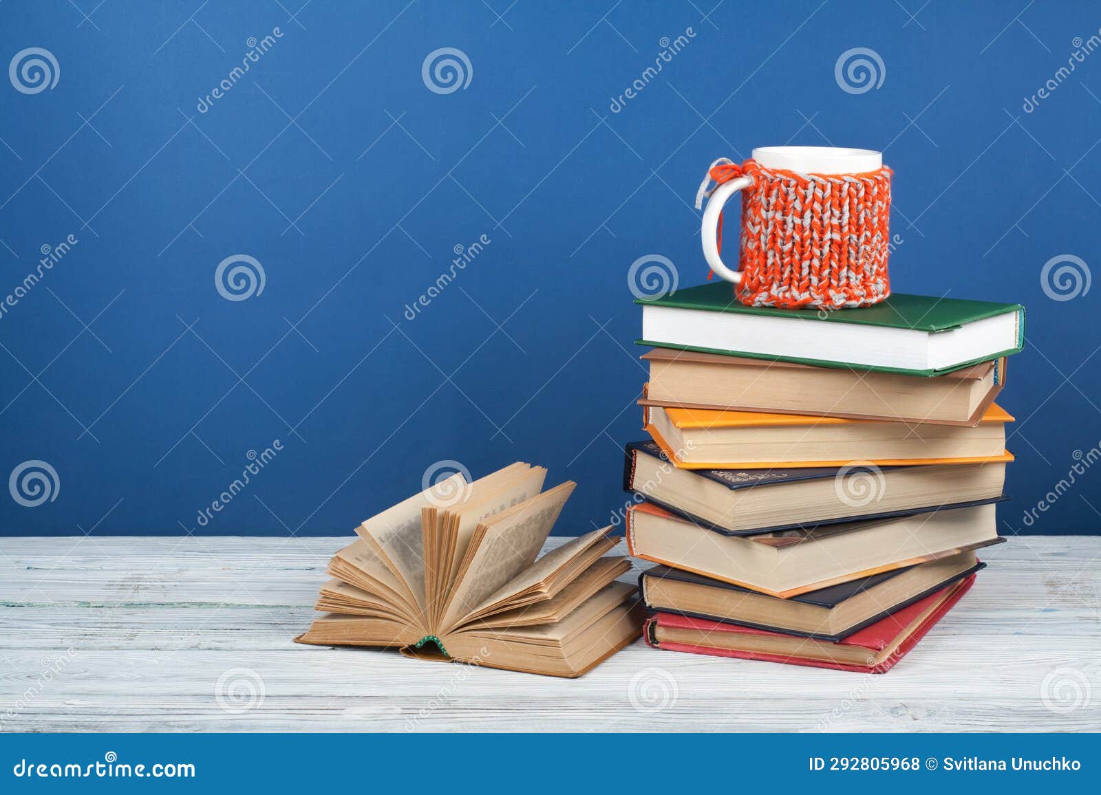 Book Stacking. Open Book, Hardback Books on Wooden Table and Blue ...
