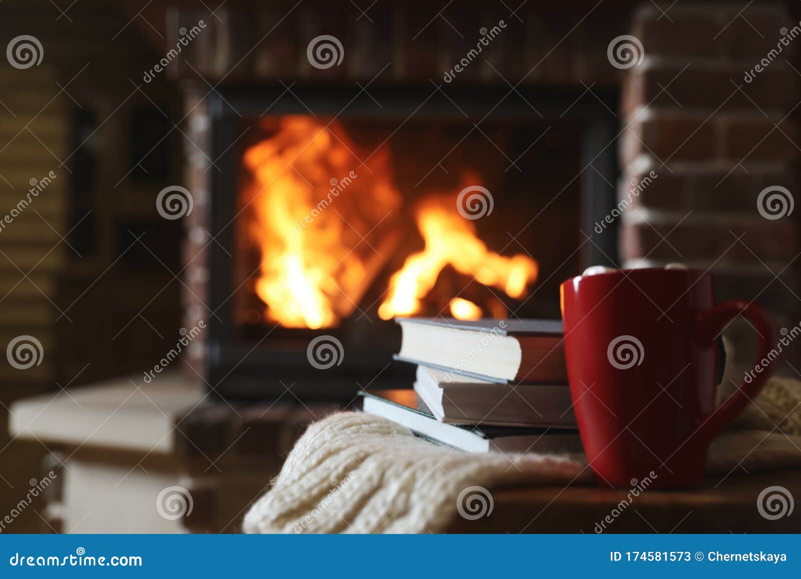 Books and Cocoa on Table Near Burning Fireplace, Space for Text ...