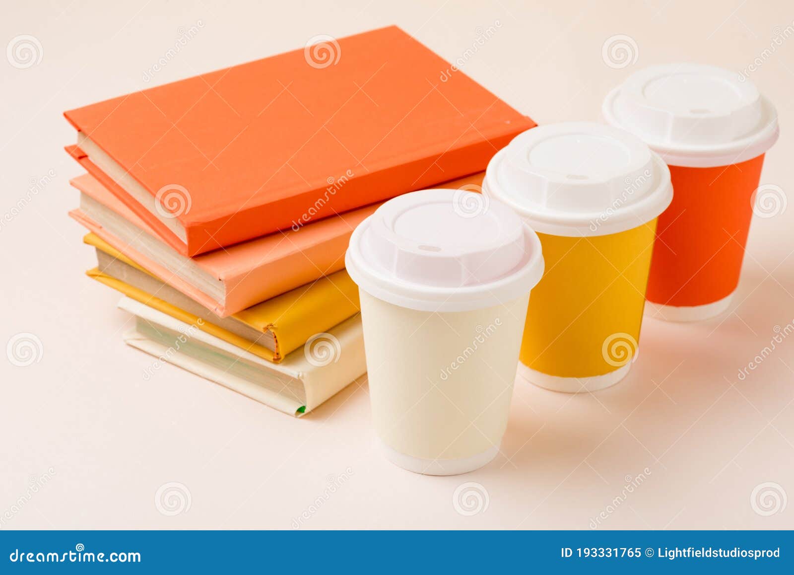 Books and Colorful Disposable Cups on Light Surface Stock Image - Image ...