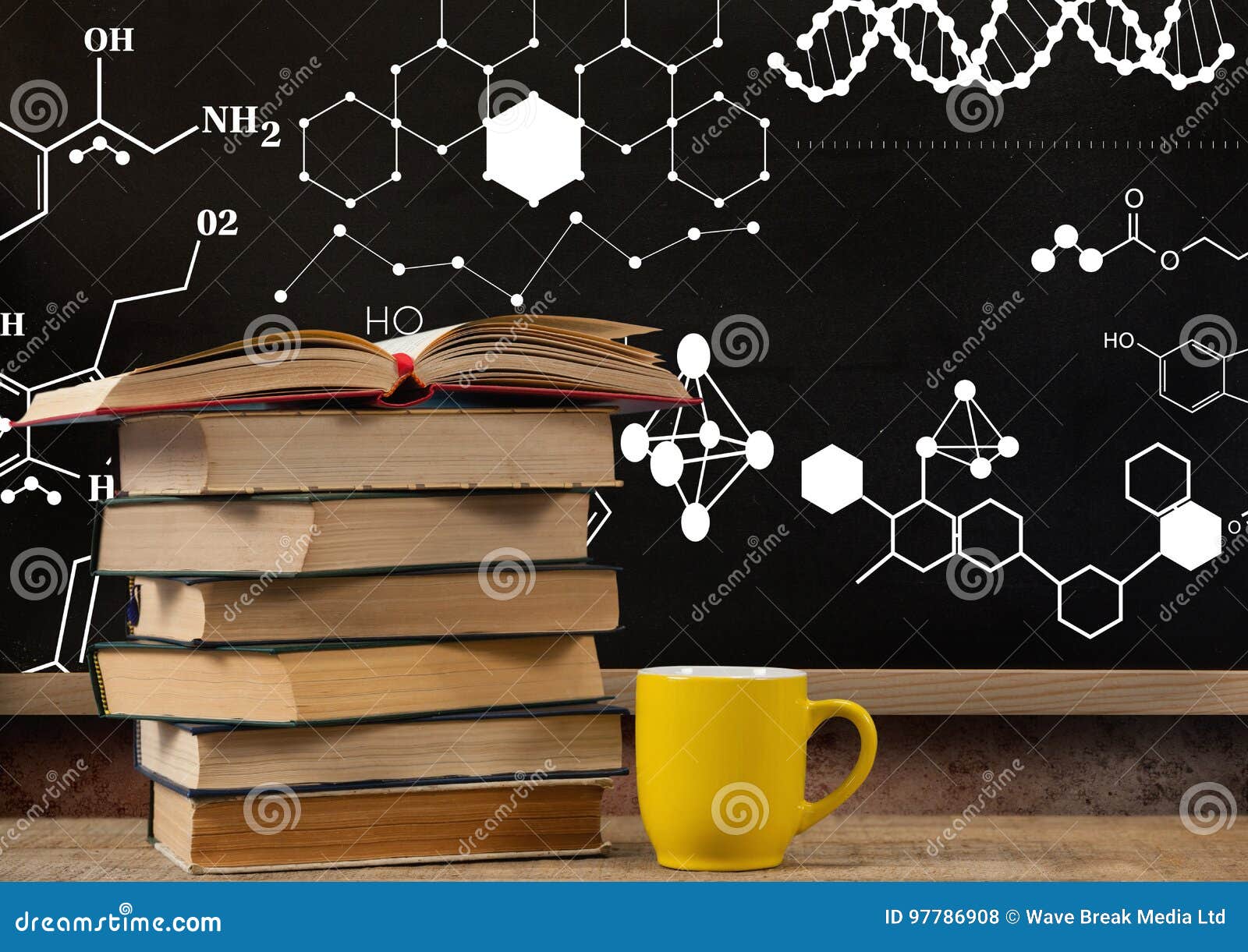 Books on Desk Foreground with Blackboard Graphics of Science Formula ...