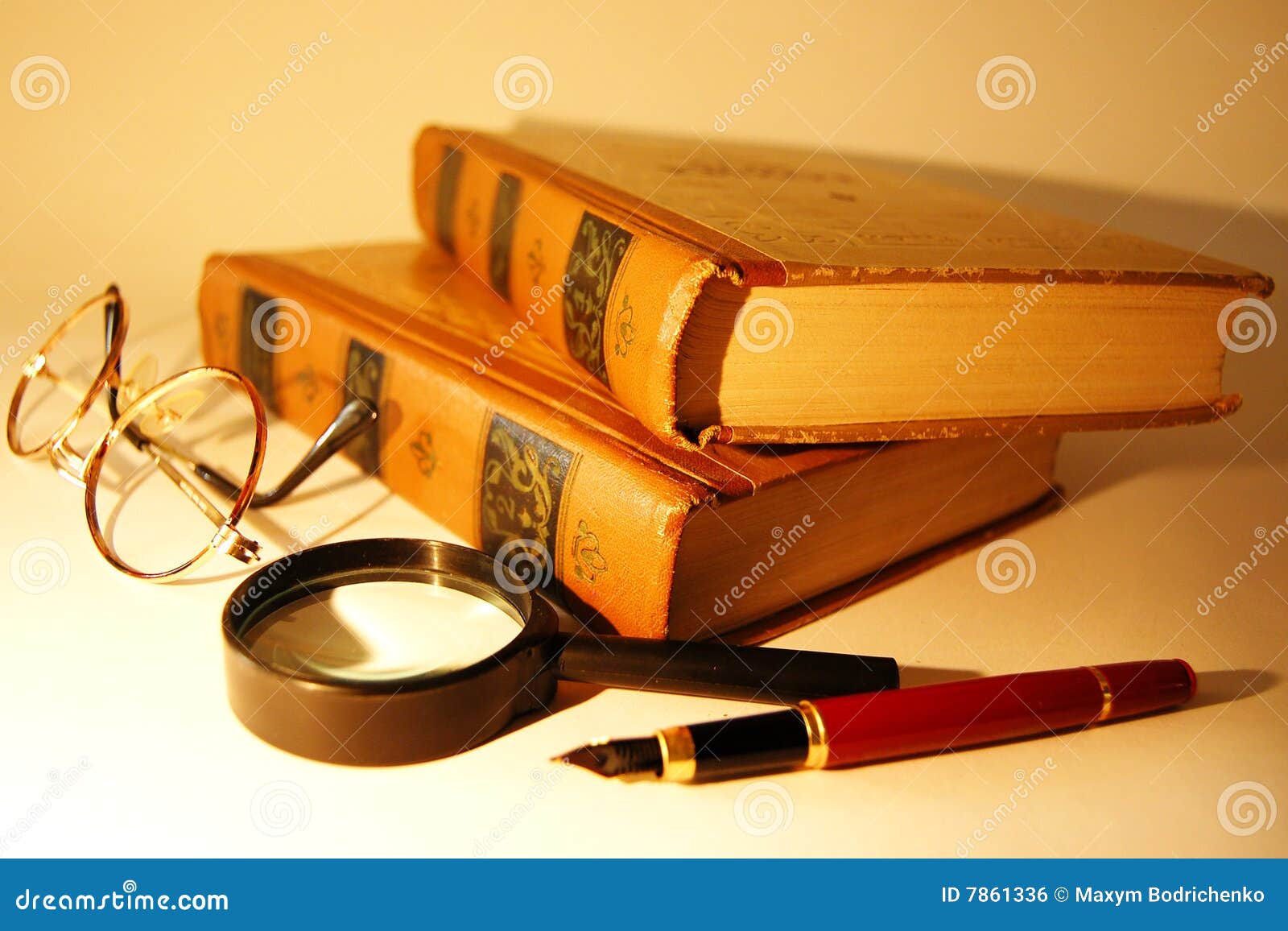 Books, glasses, magnifying glass and pen pen