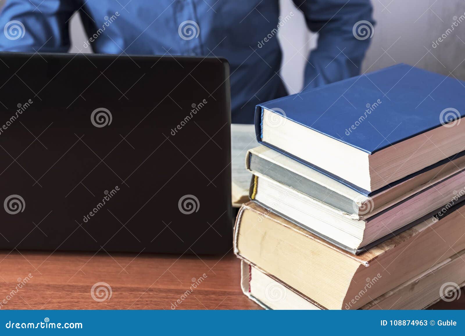 Books and Laptop on the Desktop. a Man Sits Behind a Desktop. Stock ...