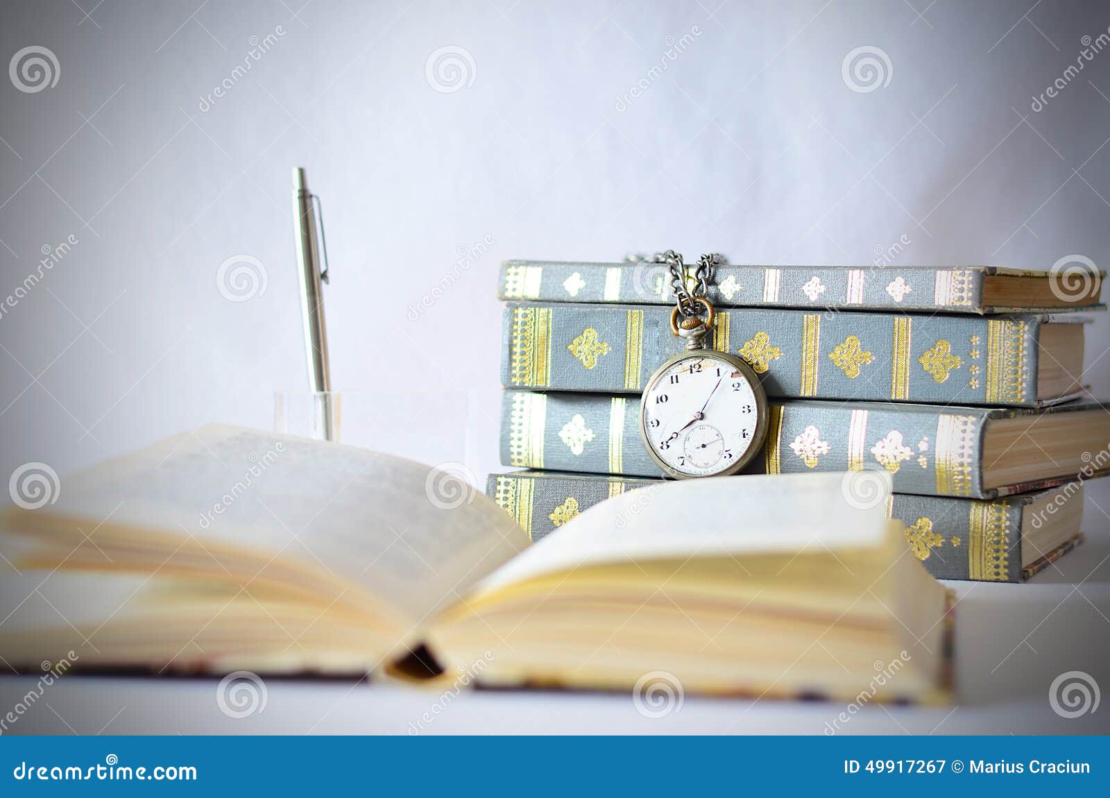 Books with old watch stock image. Image of collection - 49917267