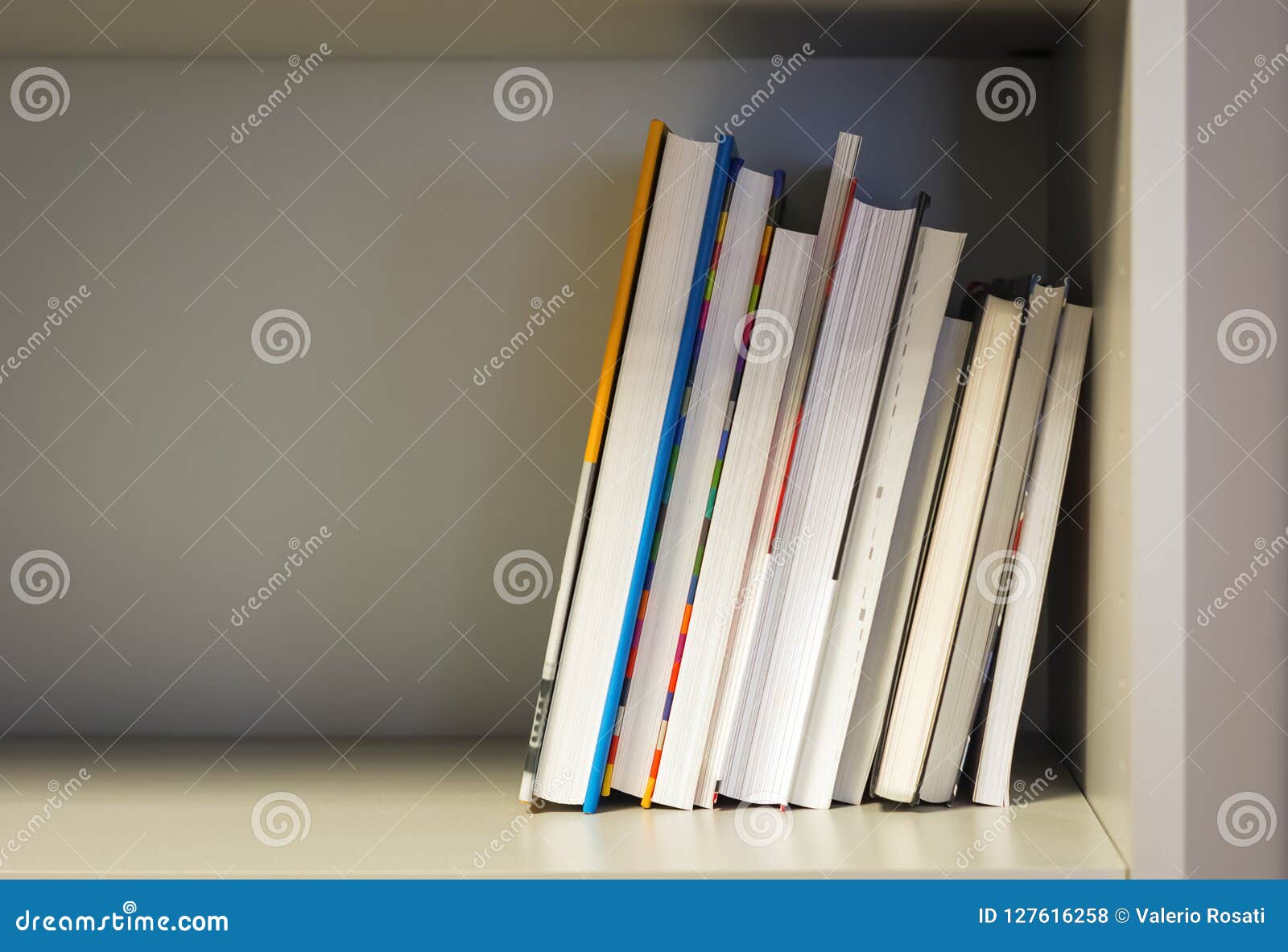 Books on a shelf stock photo. Image of objects, interior - 127616258